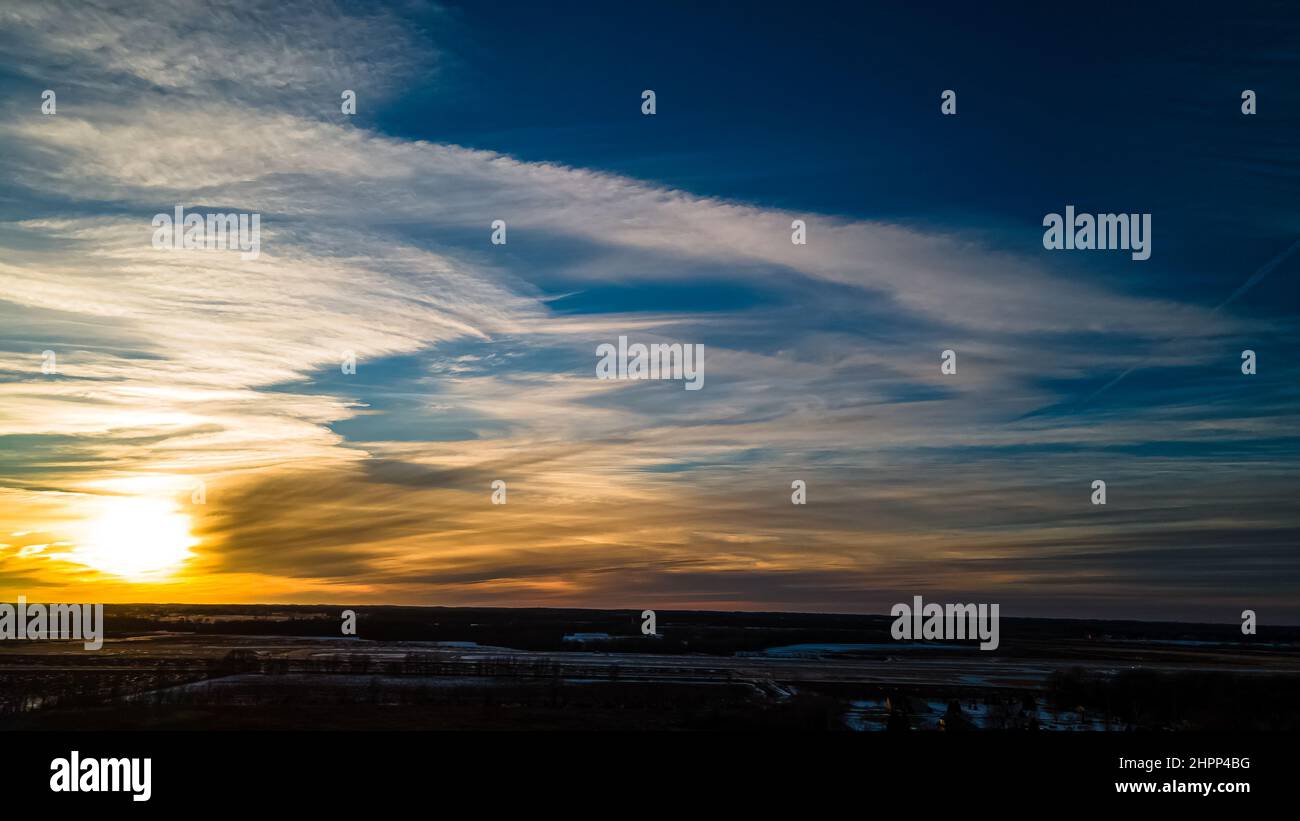 A majestic winter sunset with clouds like wings Stock Photo - Alamy