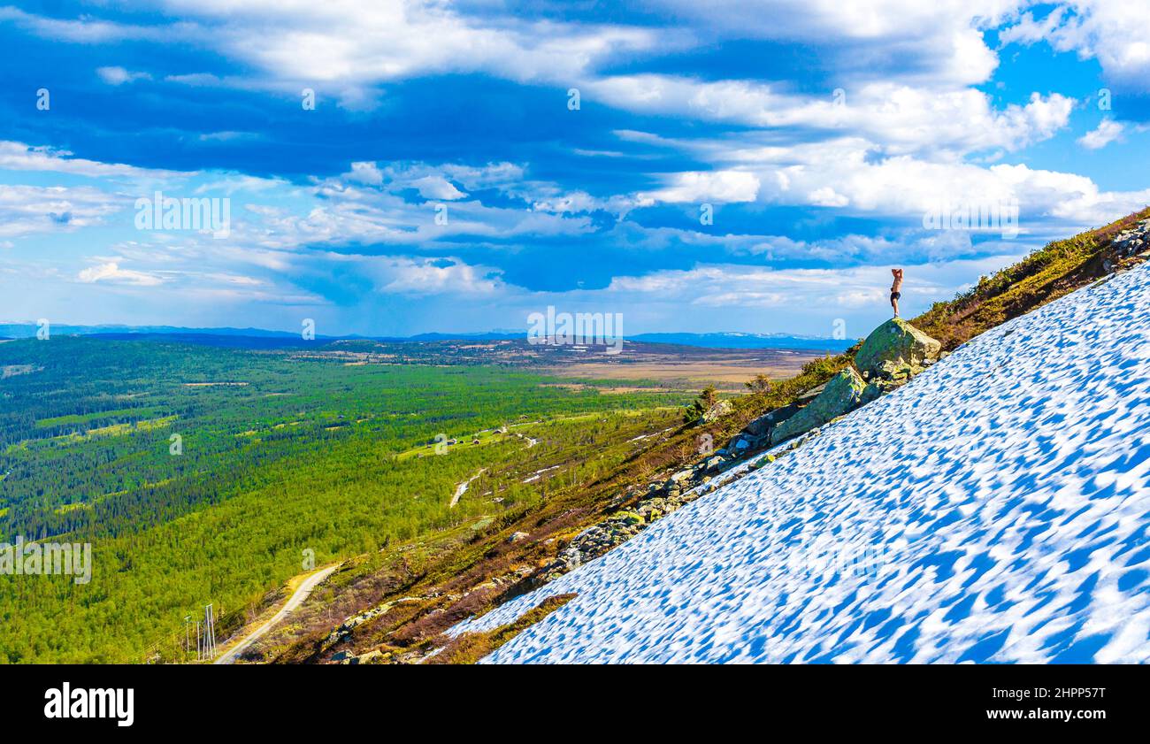 Tourist traveler and hiker on a huge rock at beautiful valley landscape ...