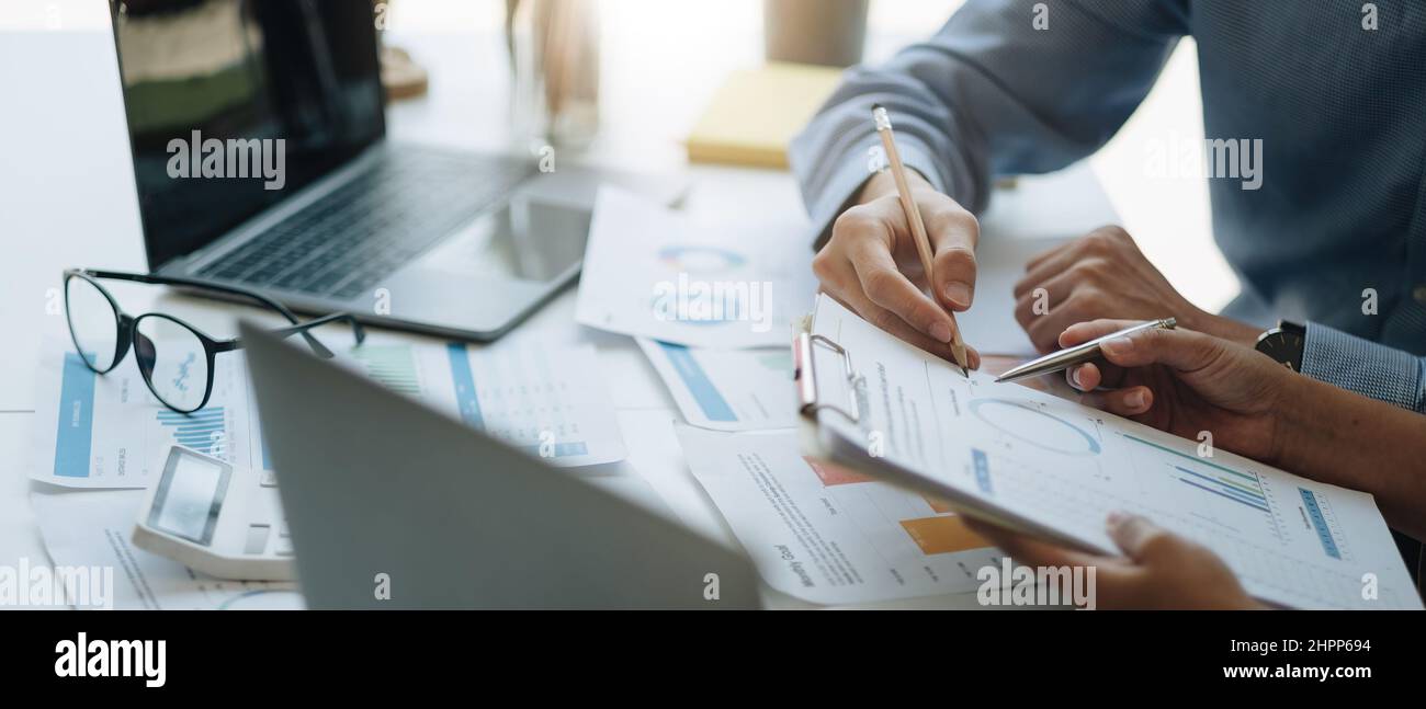 business partnership coworkers discussing a financial planning graph ...