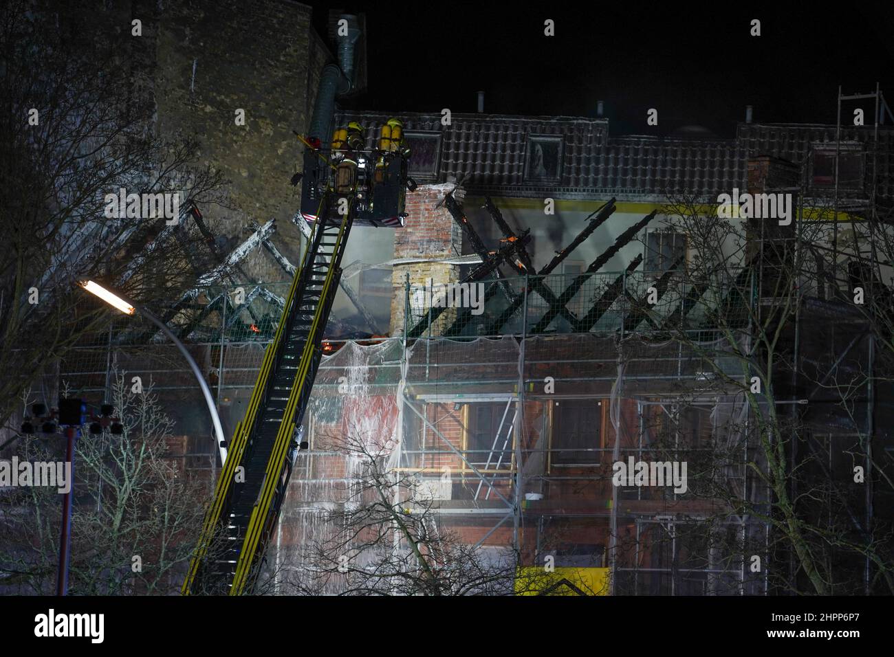 Berlin, Germany. 23rd Feb, 2022. Firefighters extinguish the fire in a ...