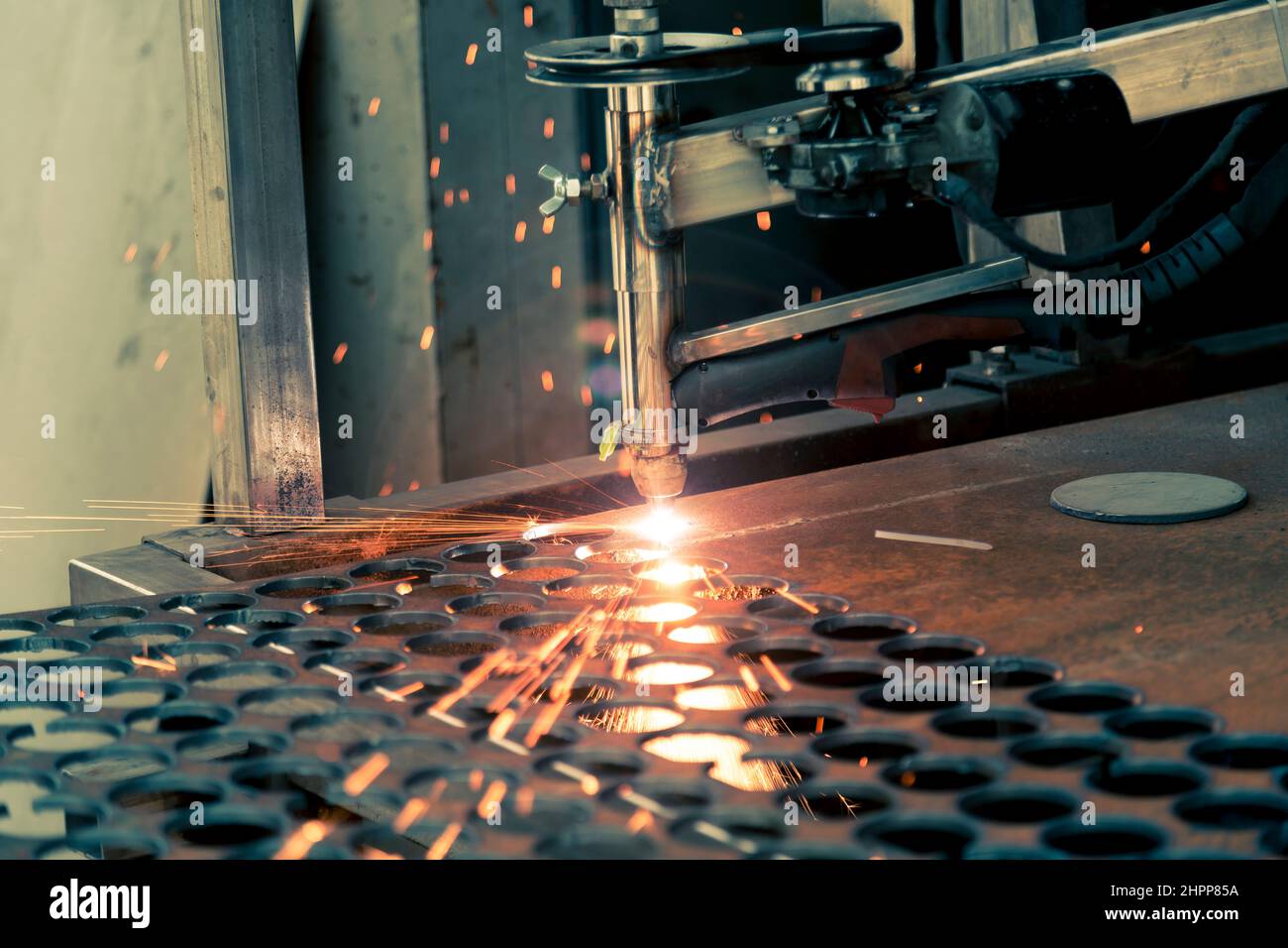 Plasma cutting machine burns through a thick sheet of steel by ...