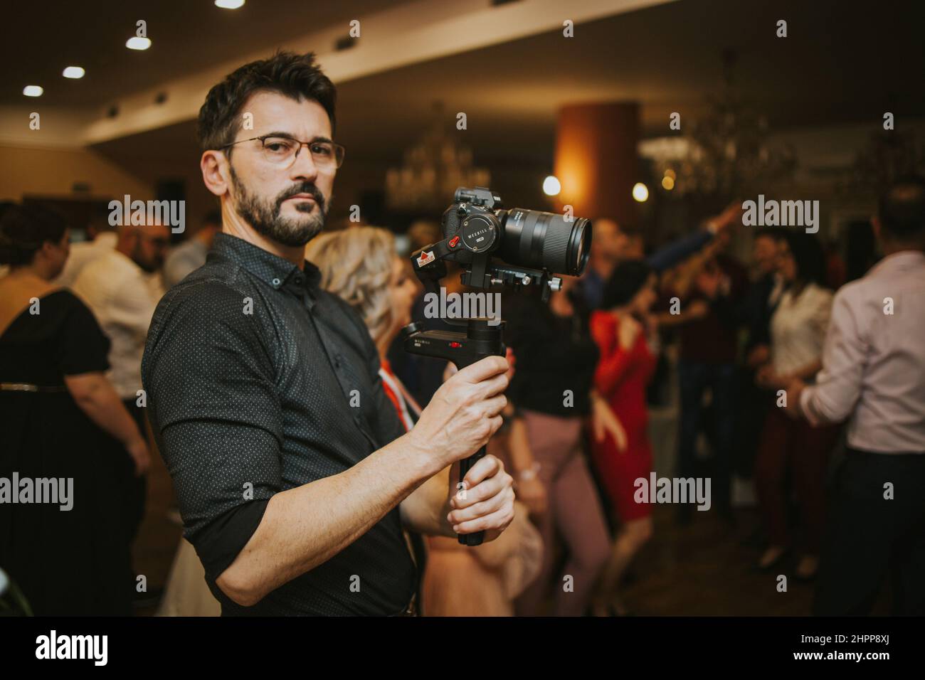 Cameraman filming an event with a professional camera using gimbal ...