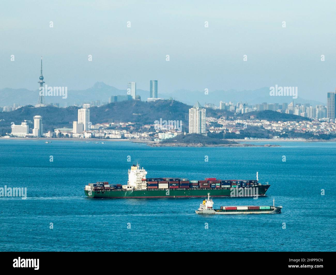 QINGDAO, CHINA - FEBRUARY 22, 2022 - A container ship enters and leaves ...