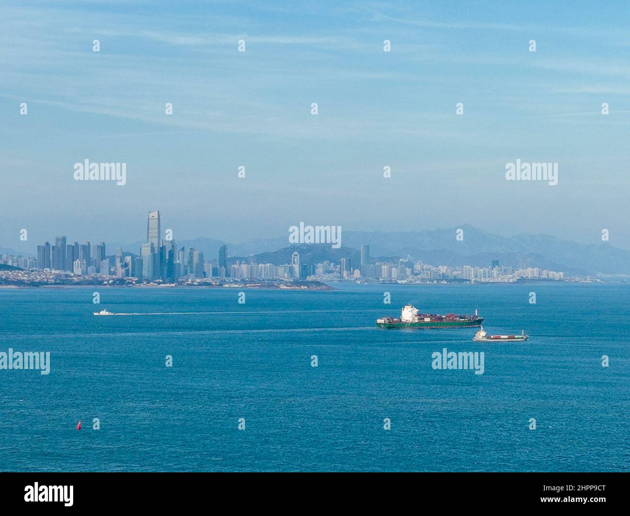 QINGDAO, CHINA - FEBRUARY 22, 2022 - A container ship enters and leaves ...