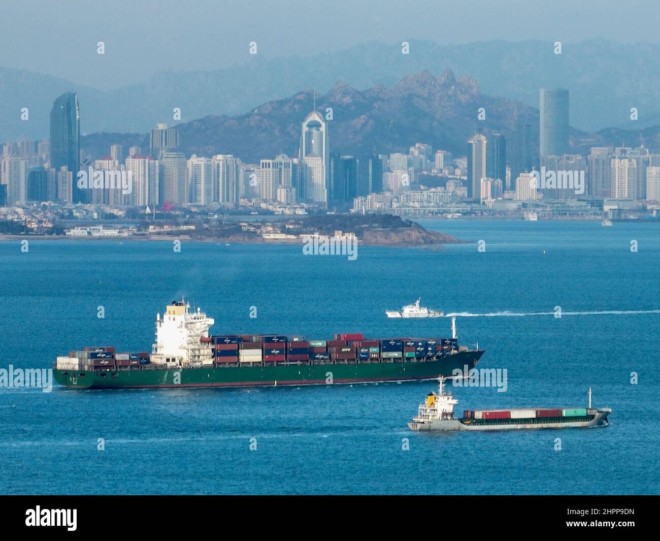 QINGDAO, CHINA - FEBRUARY 22, 2022 - A container ship enters and leaves ...