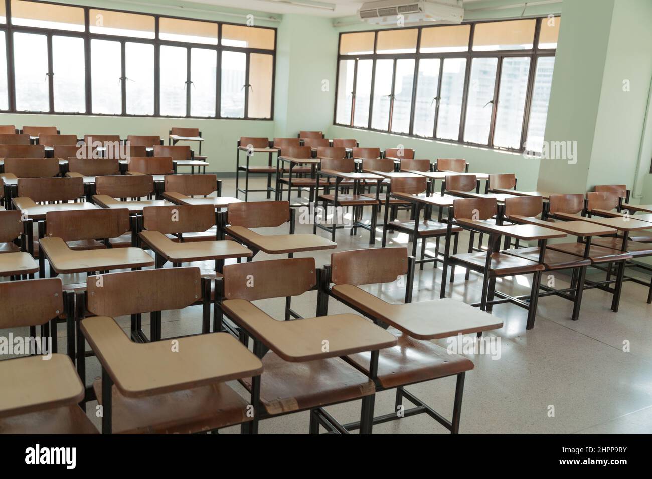 Desk and chairs in classroom background Stock Photo - Alamy