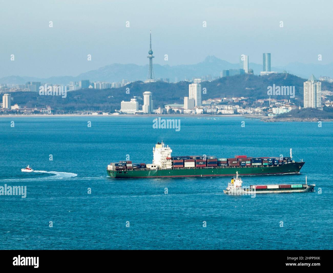 QINGDAO, CHINA - FEBRUARY 22, 2022 - A container ship enters and leaves ...