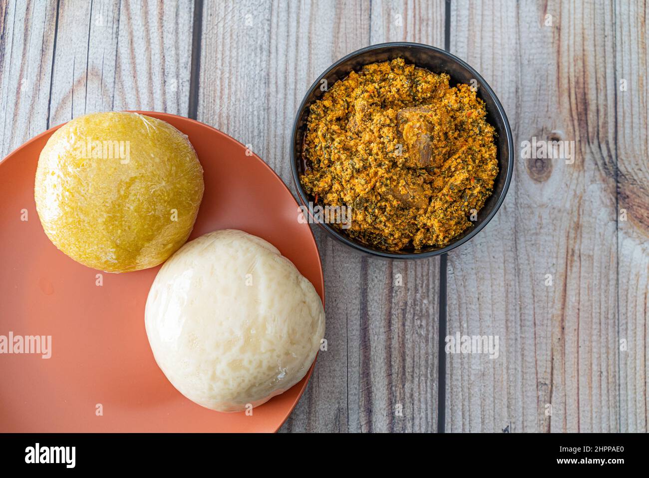 Pounded Yam and Garri Eba served with Egusi Soup ready to eat Stock ...