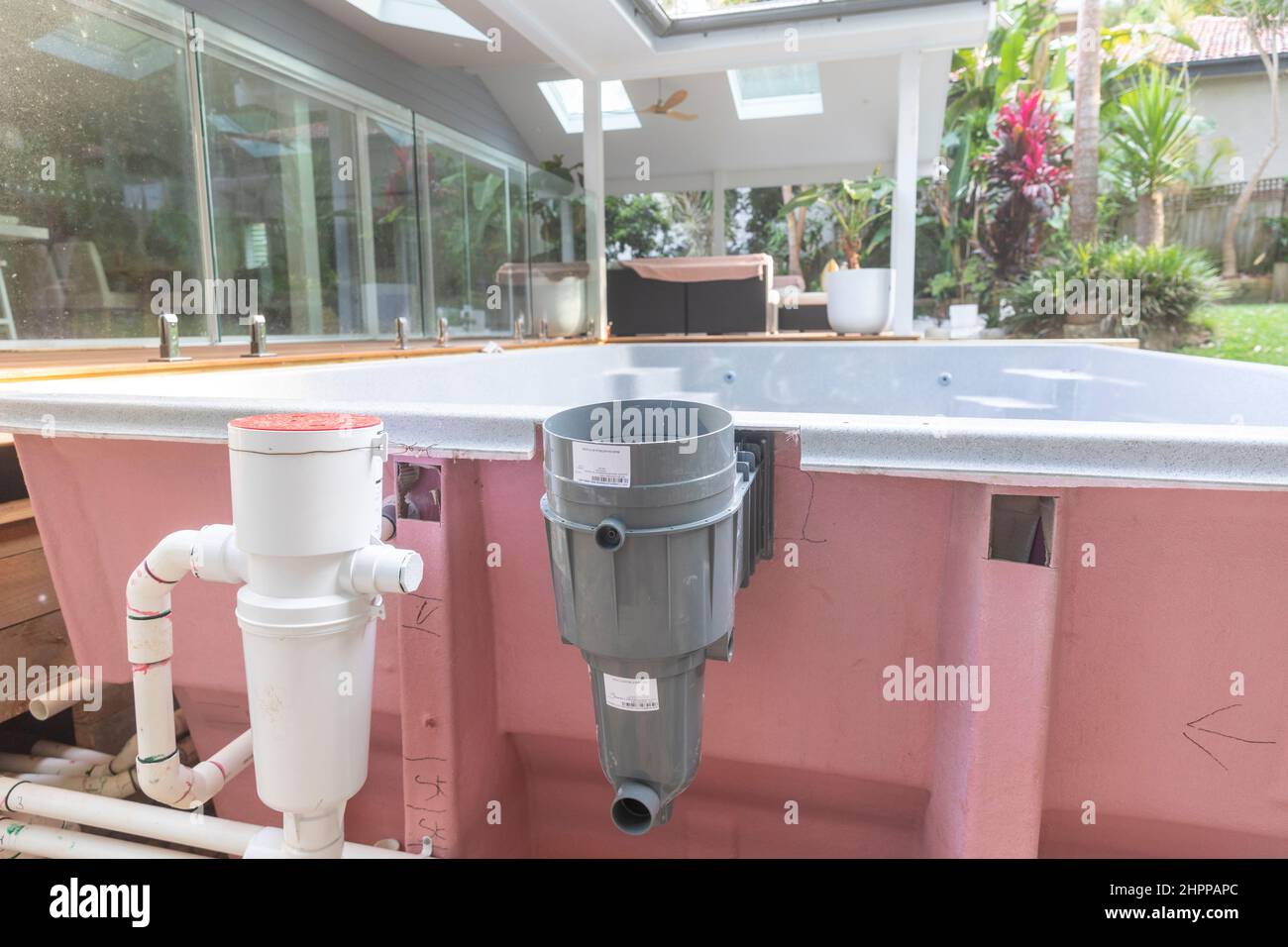 Fibreglass swimming pool in position with plastic plumbing pipework and ...