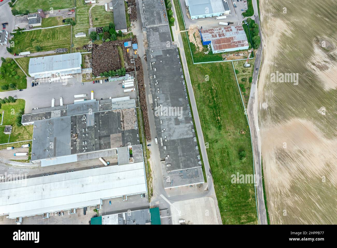 aerial view of industrial warehouse zone in suburb area. trucks are ...