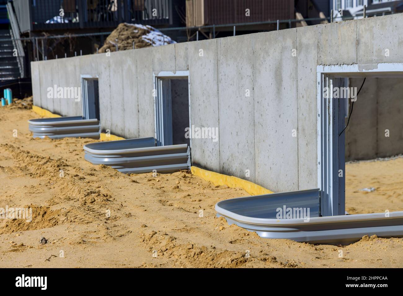 Building installation window well for basement construction on a new ...