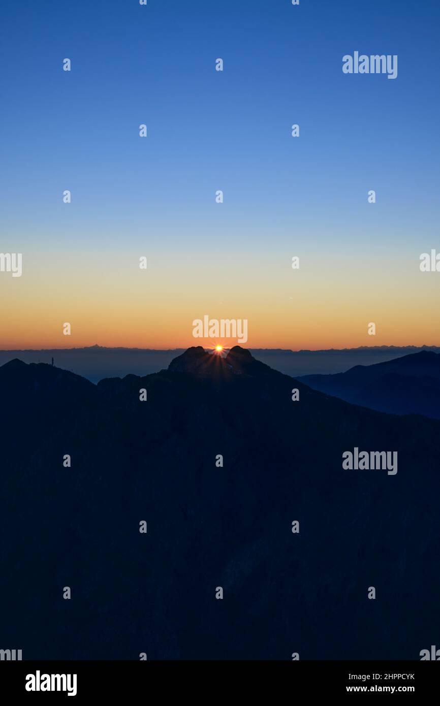 Vertical shot of a sunset and mountains Stock Photo - Alamy