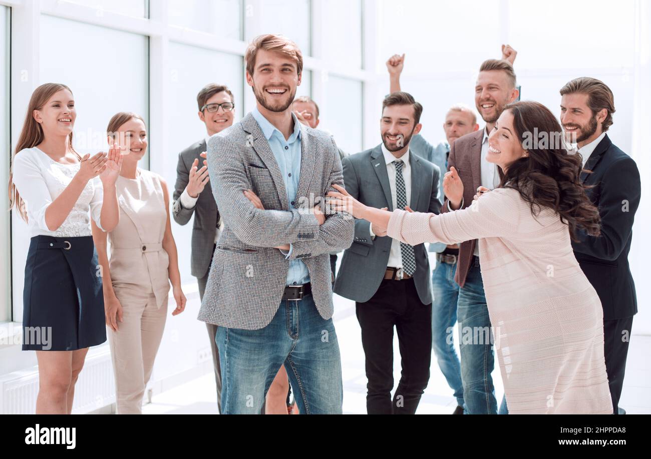 cheerful business team congratulating their leader . success concept ...