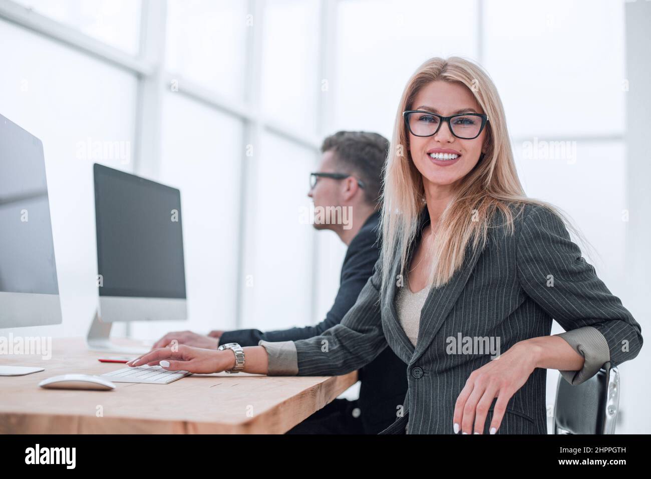 close up. a young woman works in a computer room Stock Photo - Alamy