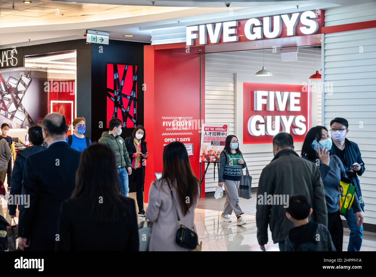 Shoppers walk past the American fast casual hamburger restaurant chain ...