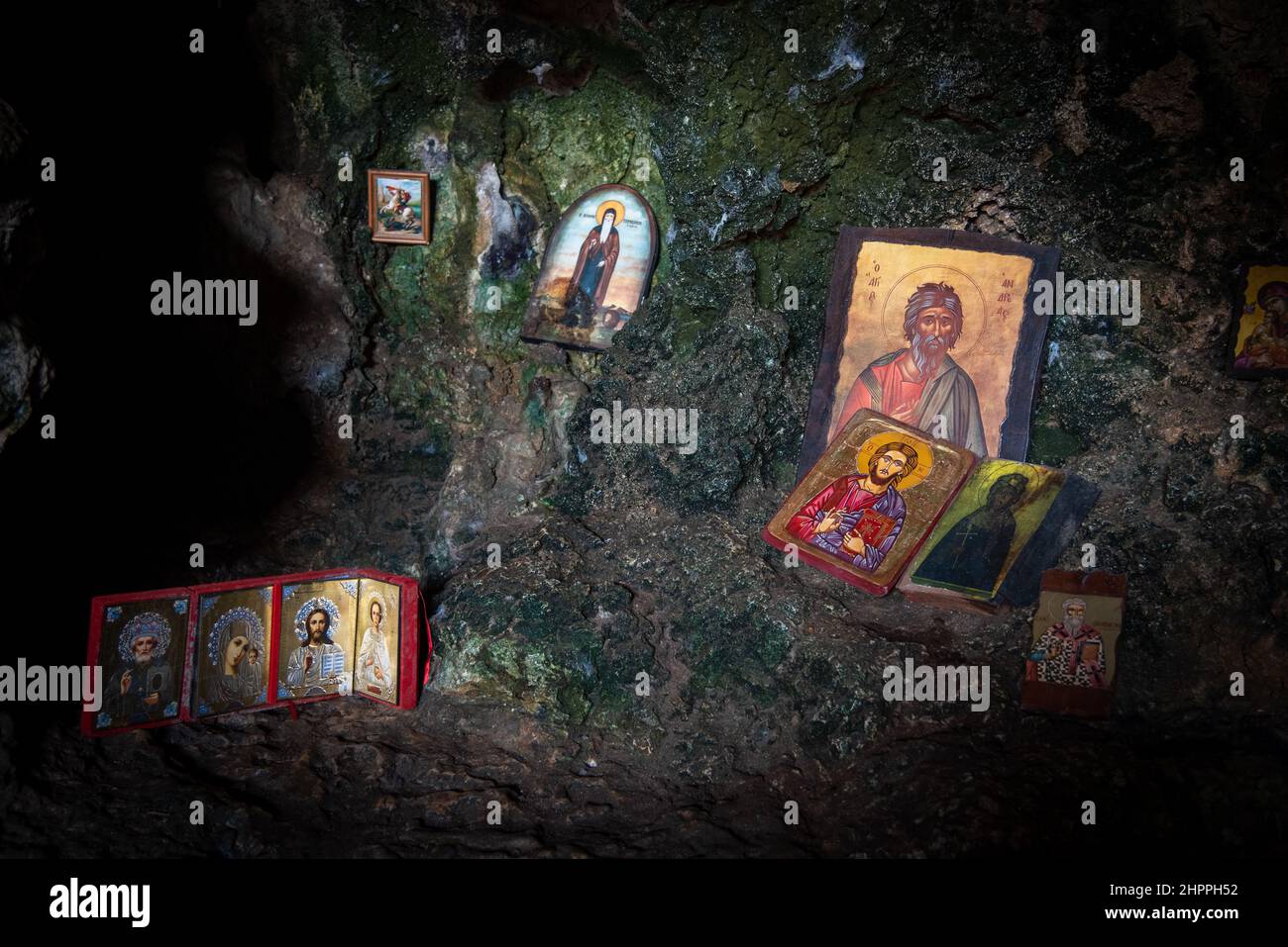 Interior of an old church cave with Christian saint pictures. Ayioi ...
