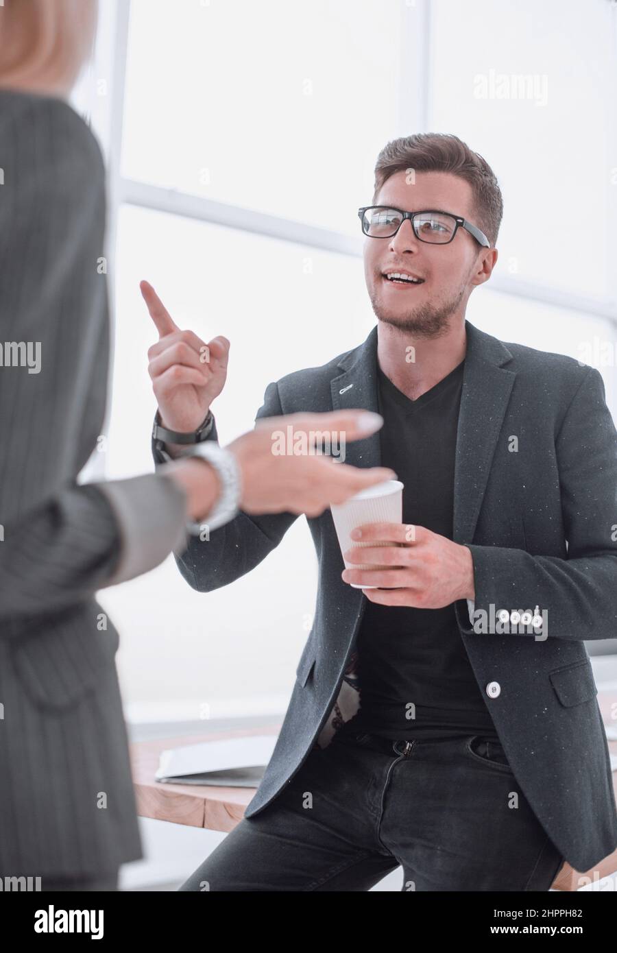 young employee explaining to a colleague his ideas Stock Photo - Alamy