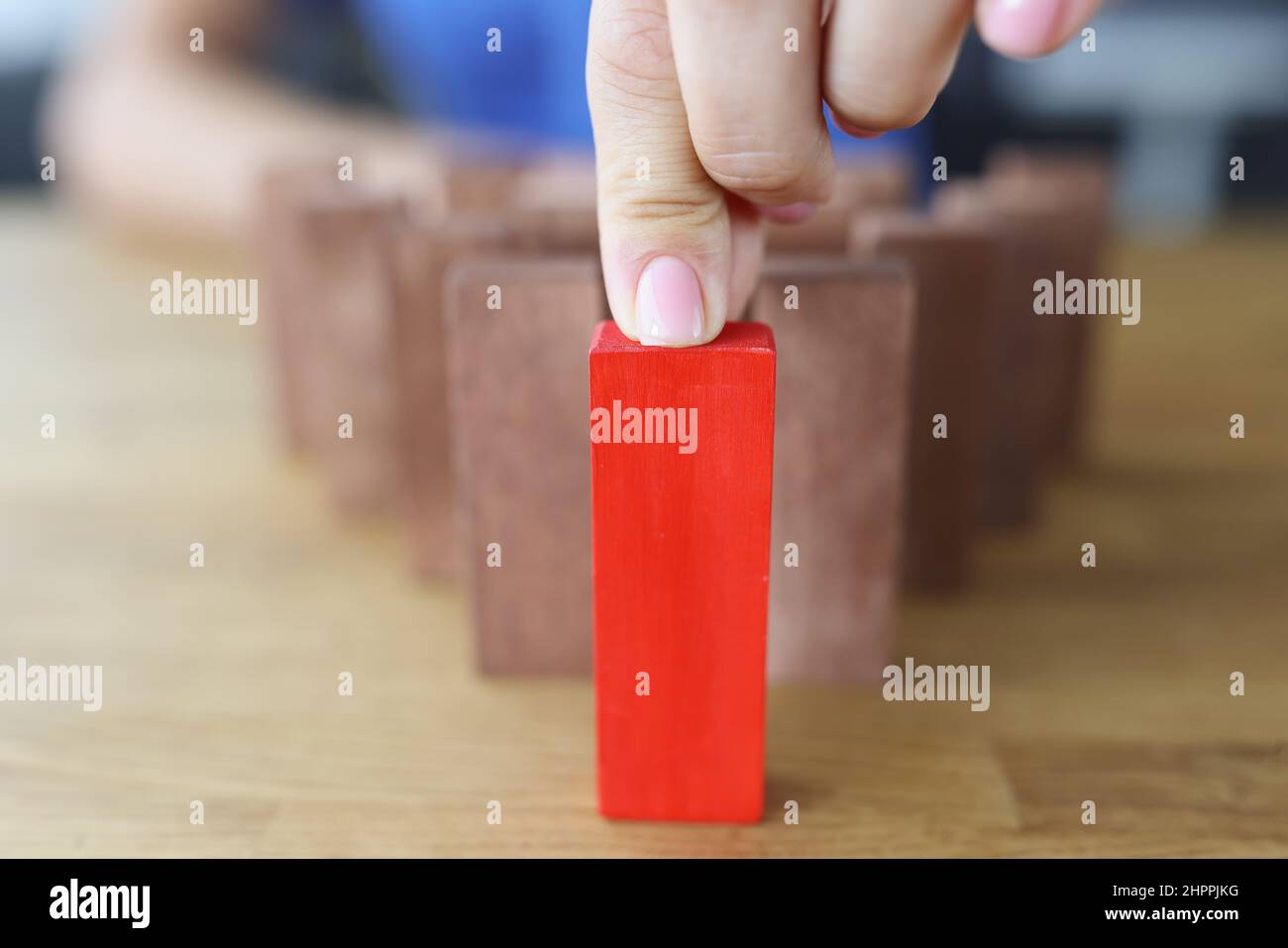 One different red cube block among wooden blocks closeup Stock Photo ...