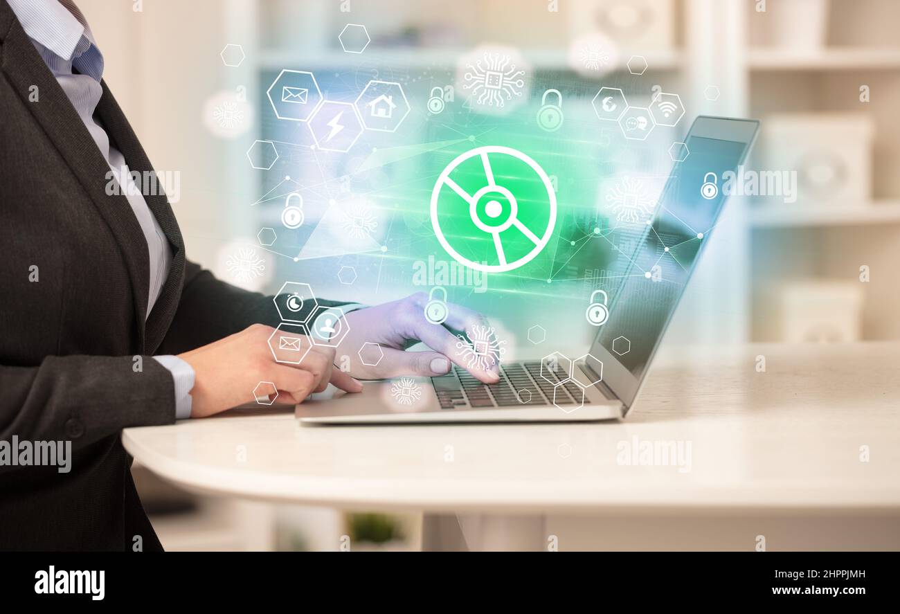 Hands working on laptop with digital icons Stock Photo - Alamy