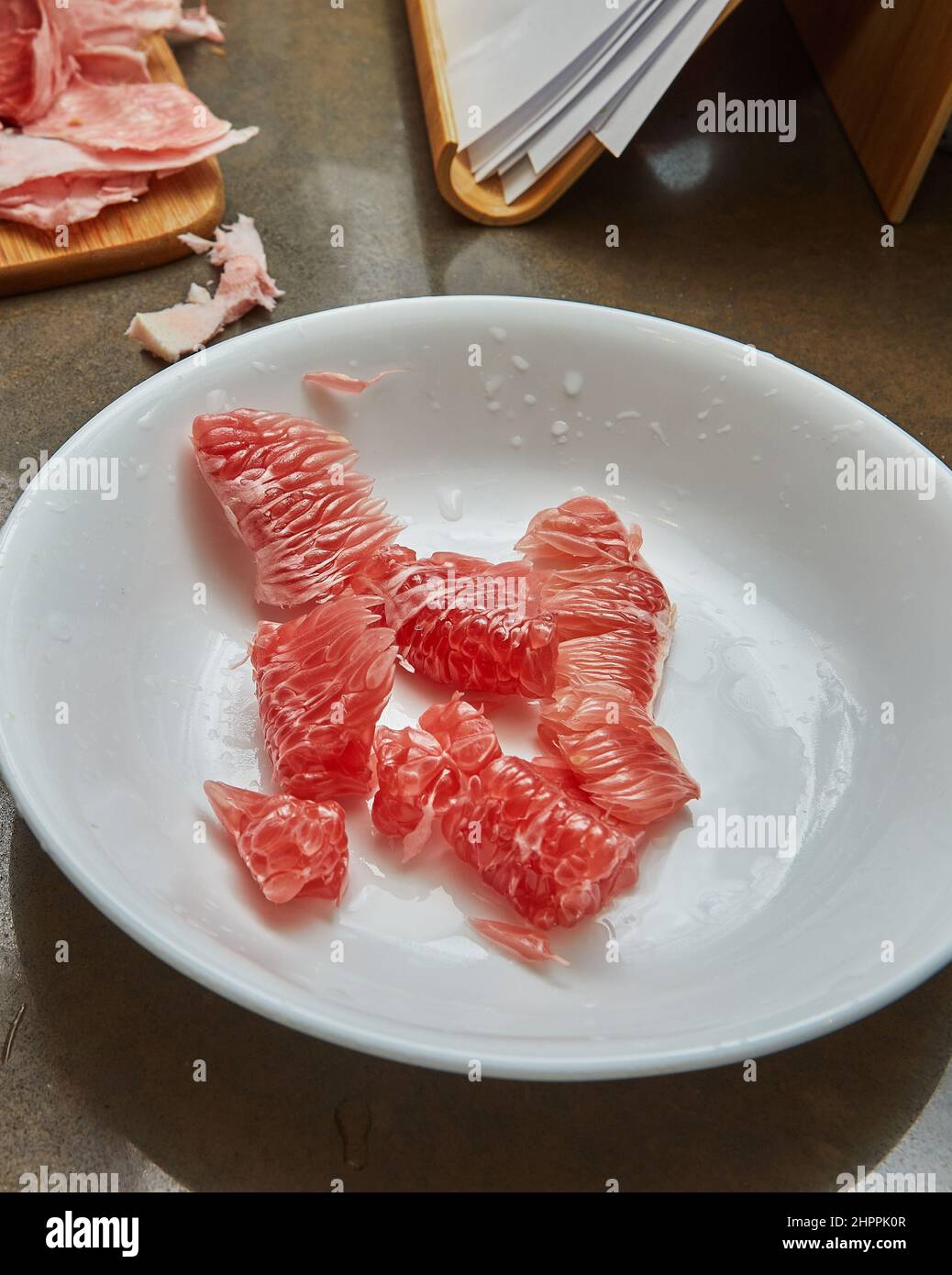 Red pomelo slices lie on plate ready for cooking Stock Photo - Alamy