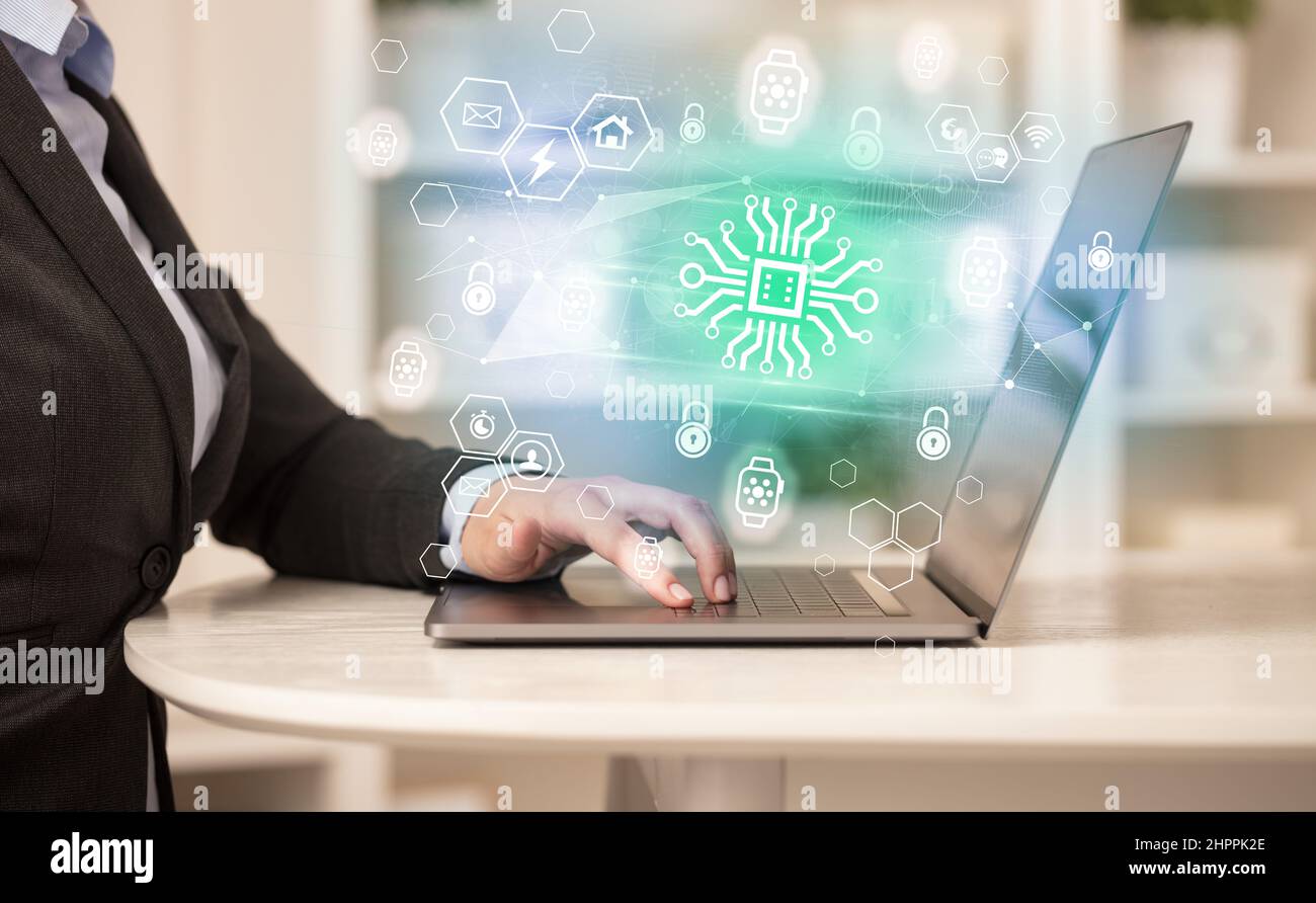 Hands working on laptop with digital icons Stock Photo - Alamy