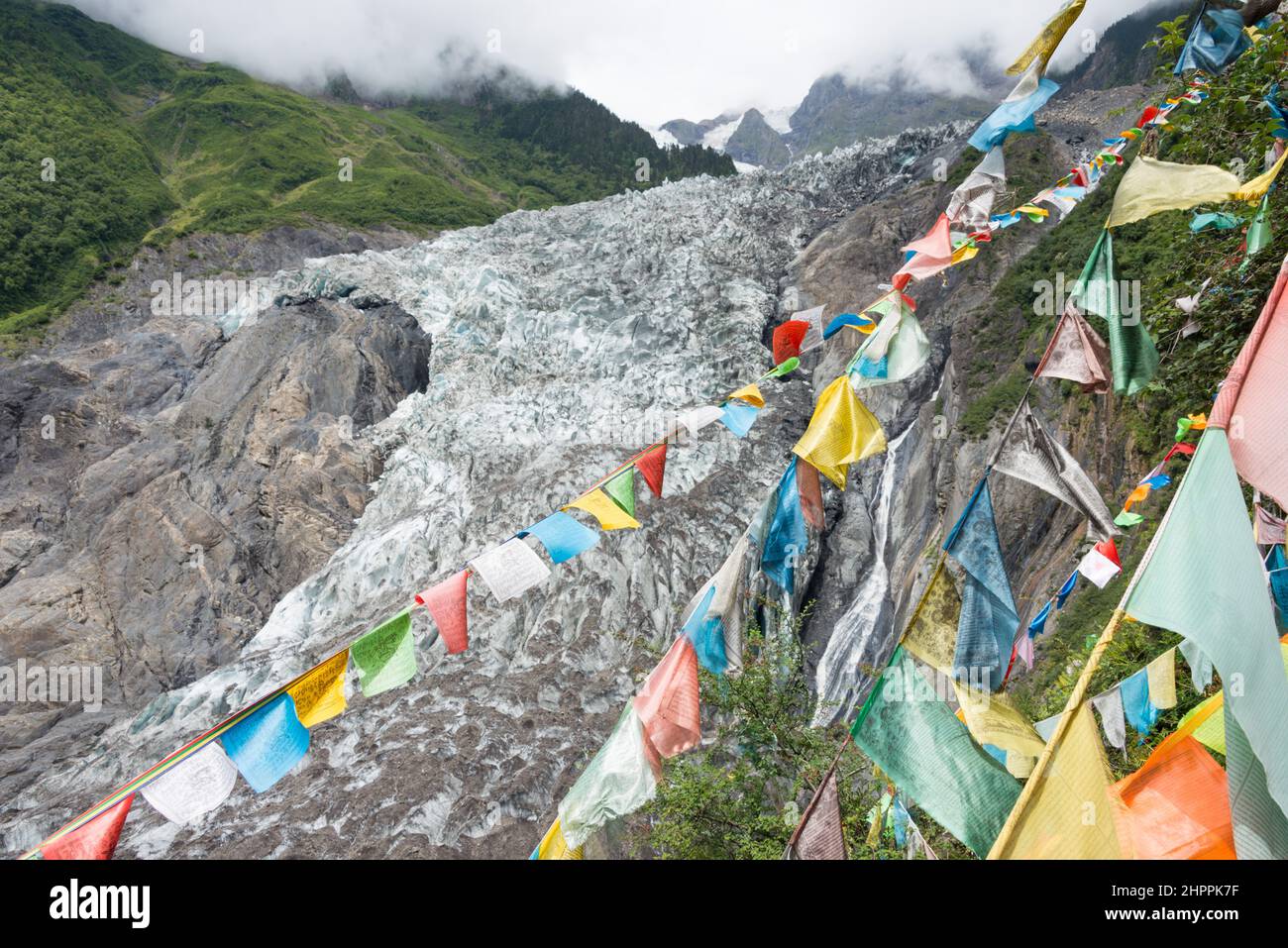 DEQIN, CHINA - Prayer flags at Minyong Glacier. a famous landscape in ...
