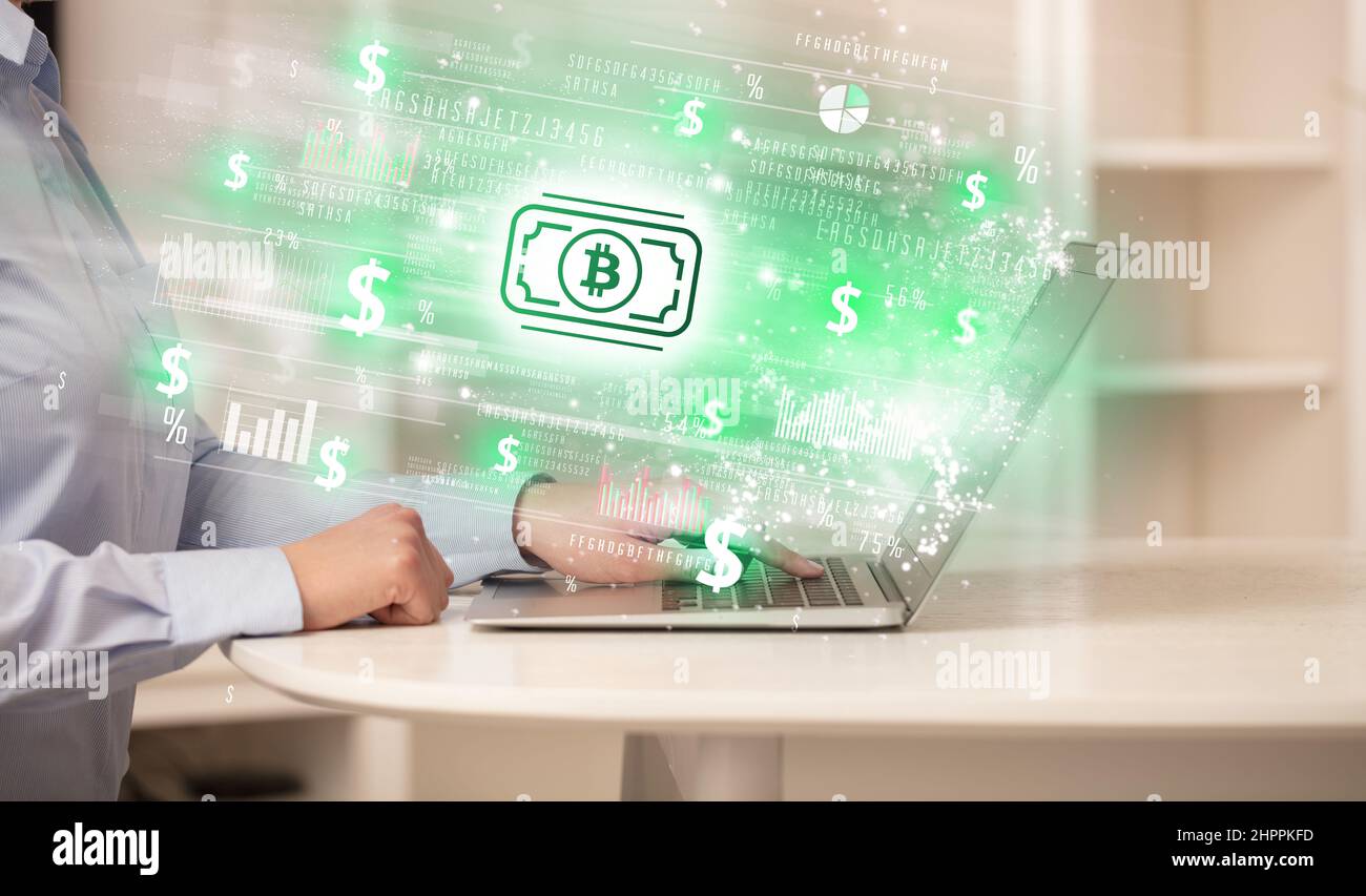Young man watching stock market on laptop Stock Photo - Alamy