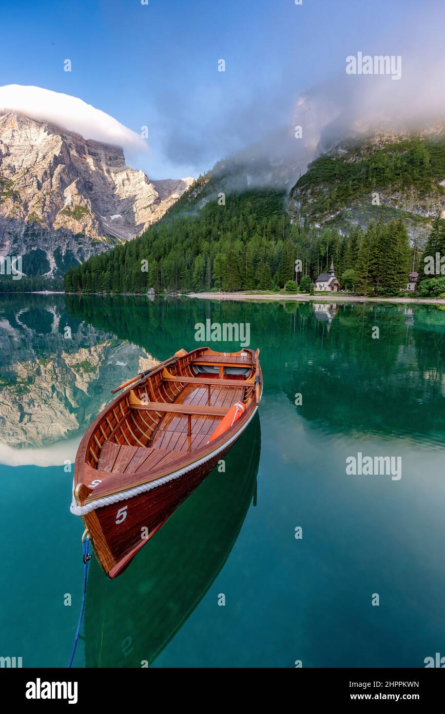 Vertical shot of an empty rowboat swimming in the lake in the ...