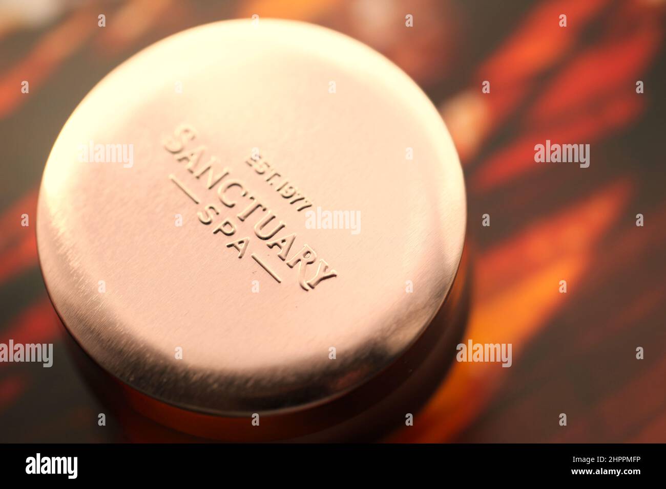 Sanctuary Spa Close-up of Sanctuary Spa Pamper Candle on tawny-red ...
