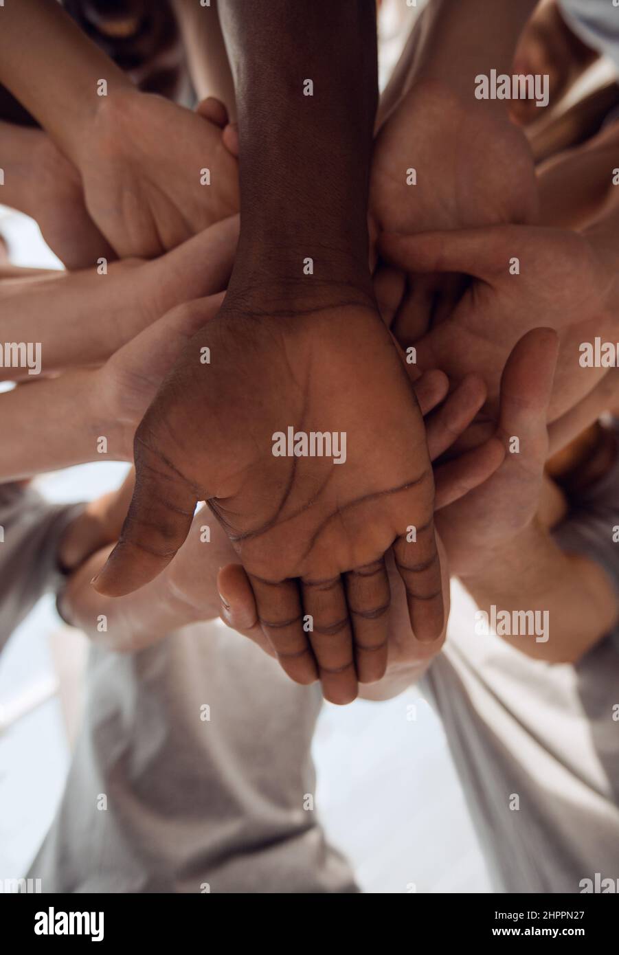 smiling young people making a tall tower out of their hands Stock Photo ...