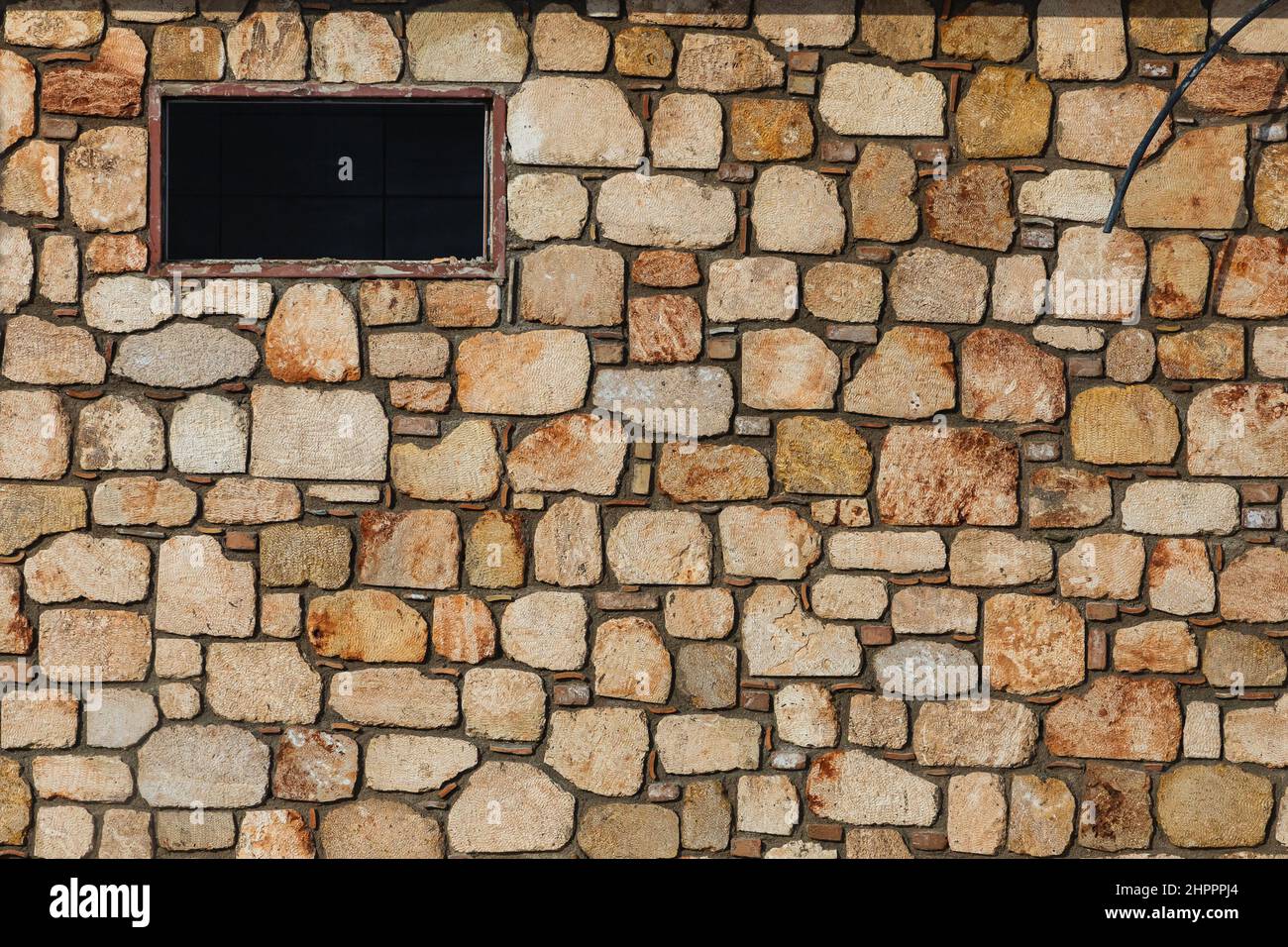 Texture of a stone wall with a small window. Background texture of the ...