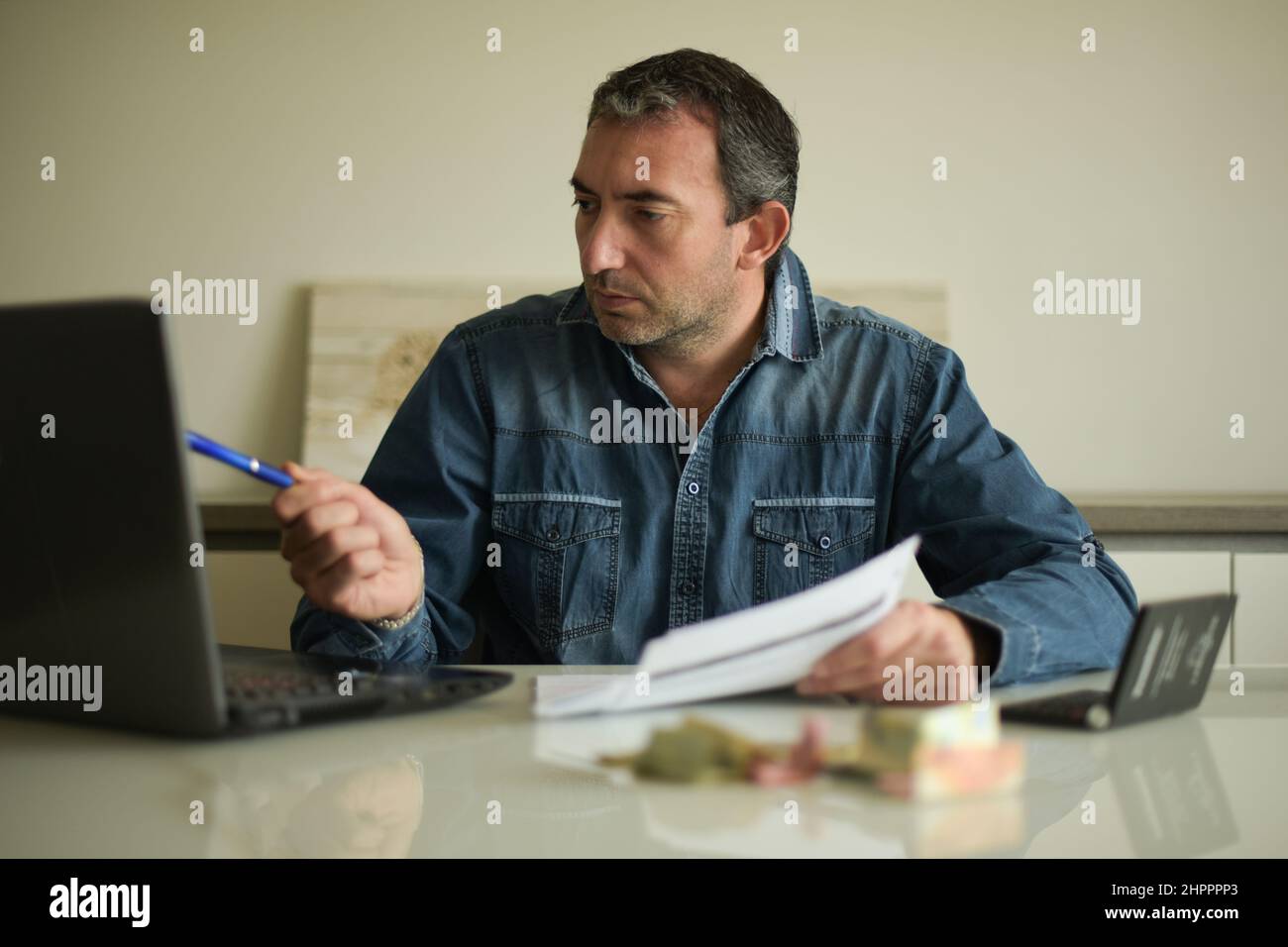 man checking his bills at home Stock Photo - Alamy