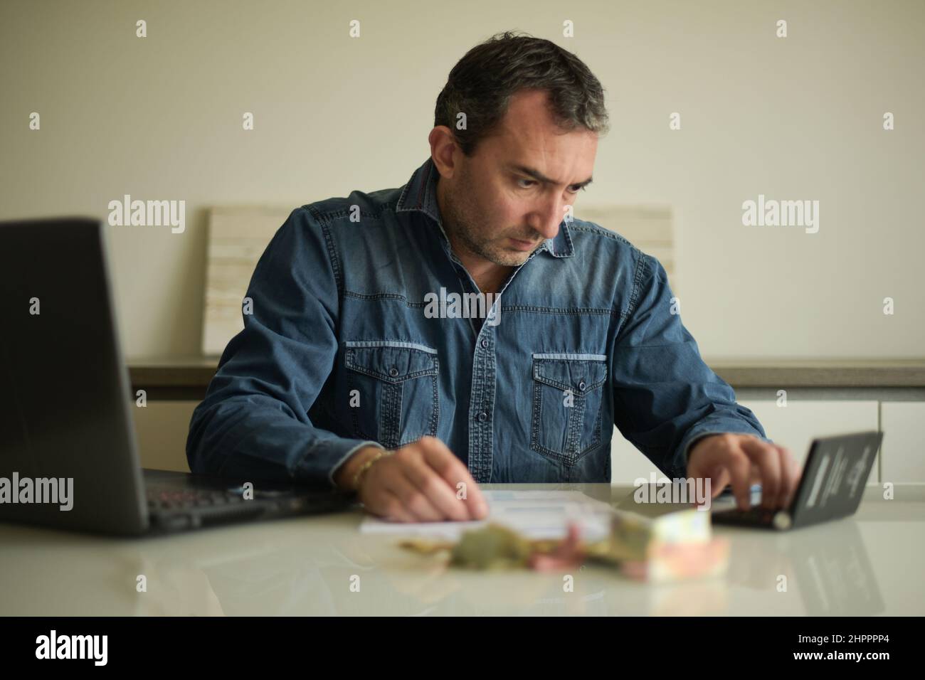 man checking his bills at home Stock Photo - Alamy