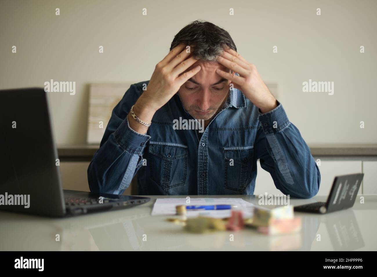 man checking his bills at home Stock Photo - Alamy