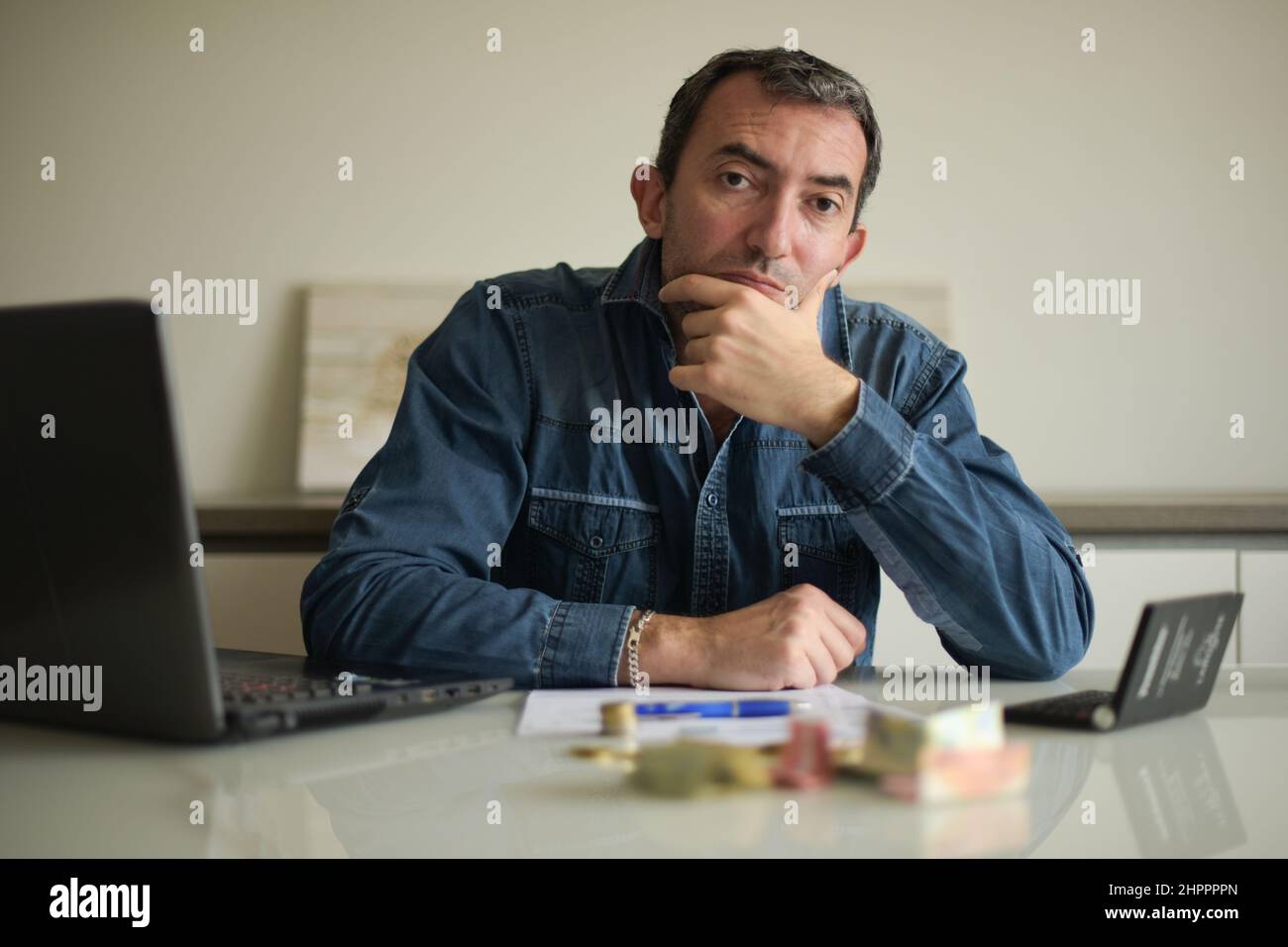 man checking his bills at home Stock Photo - Alamy