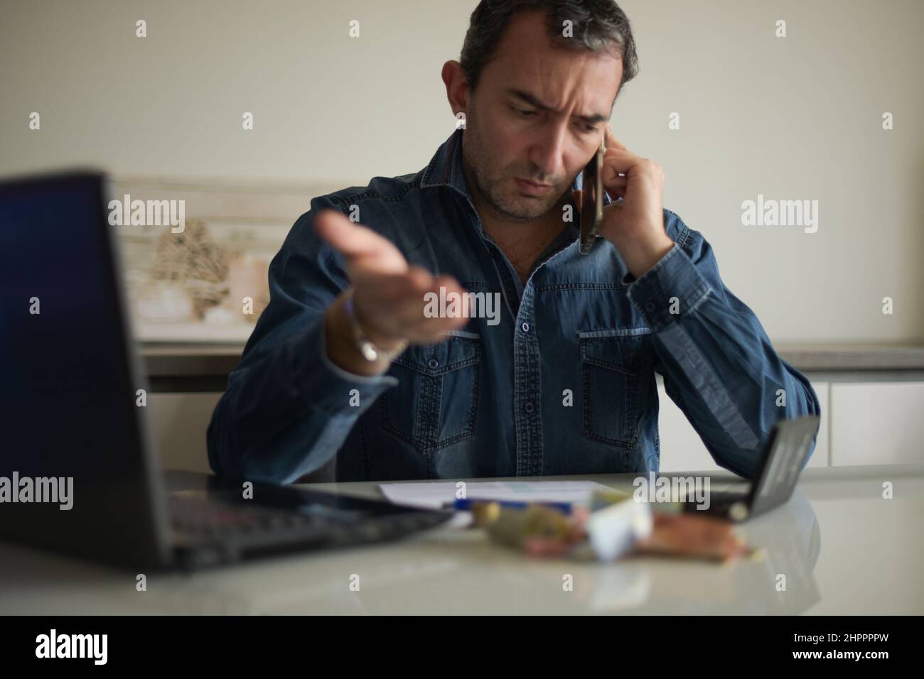 man checking his bills at home Stock Photo - Alamy