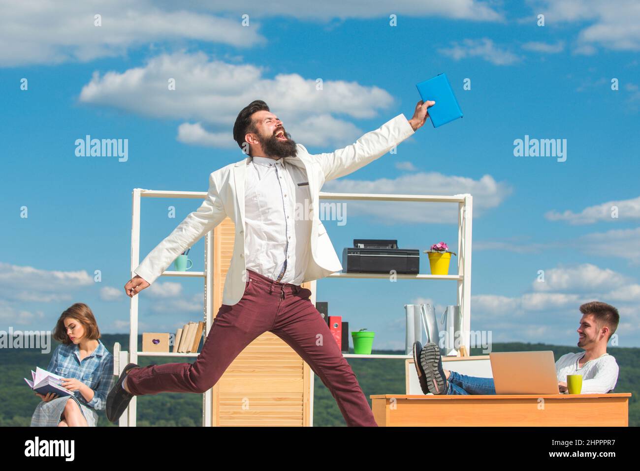 Funny businessman jump on background of colleagues. Excited office ...