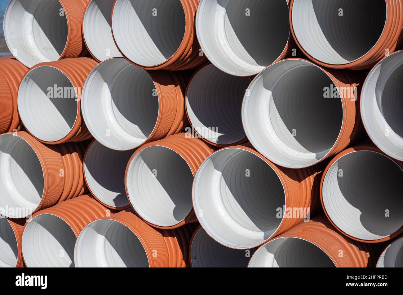 Close-up Stack of new orange polypropylene pipes. Plastic pipes for ...