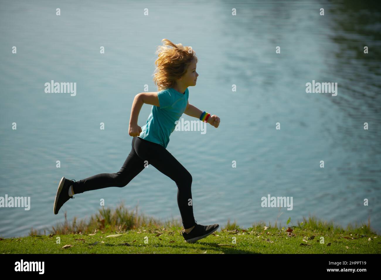 Child runners run in park. Boy running in the park in summer in nature ...