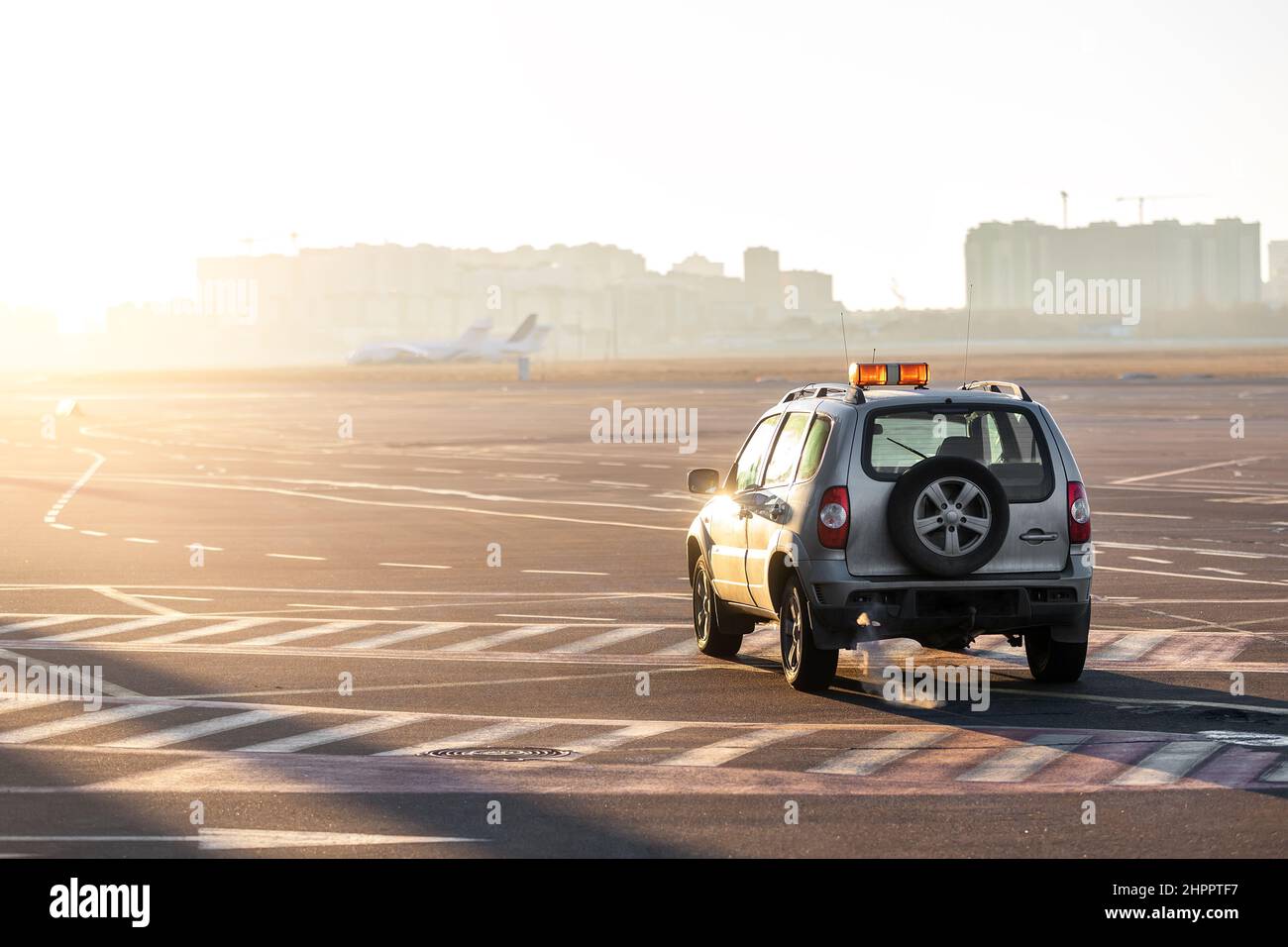 Scenic view of airport security car on tarmac apron taxiway in warm ...