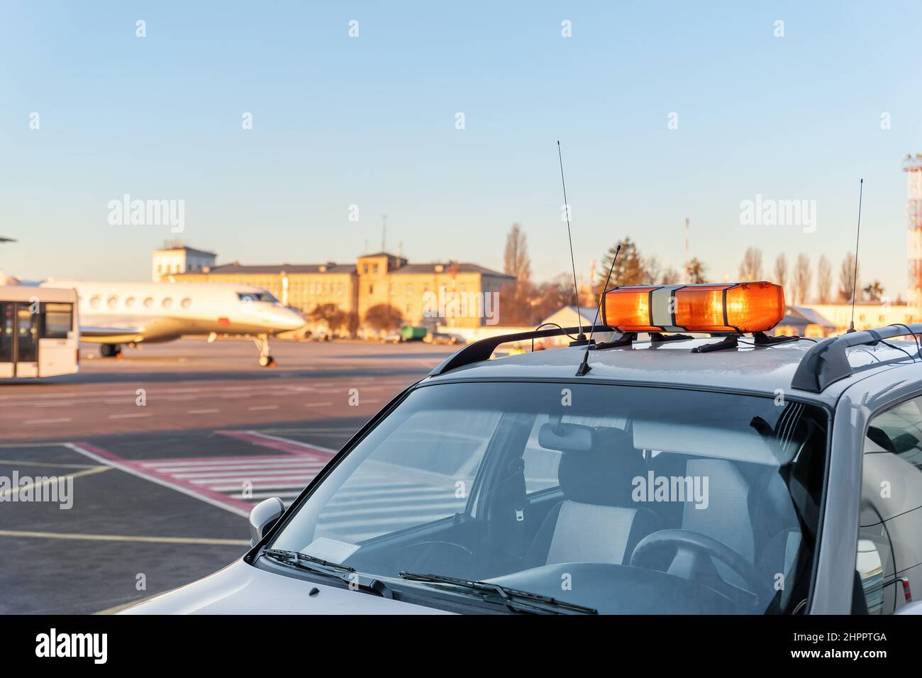Scenic view of airport security car on tarmac apron taxiway in warm ...