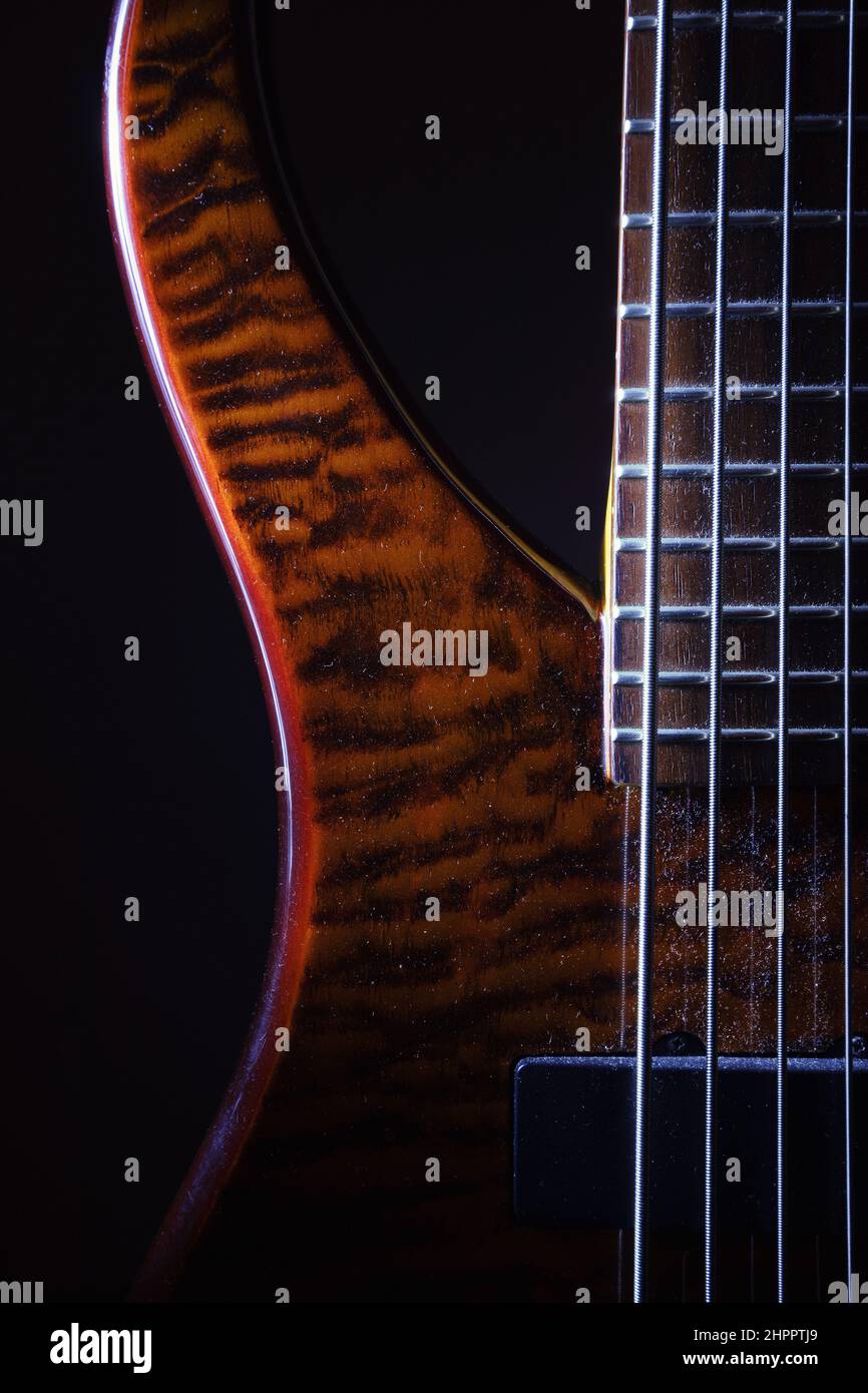 Details of modern but dusty five strings bass guitar, body and neck ...