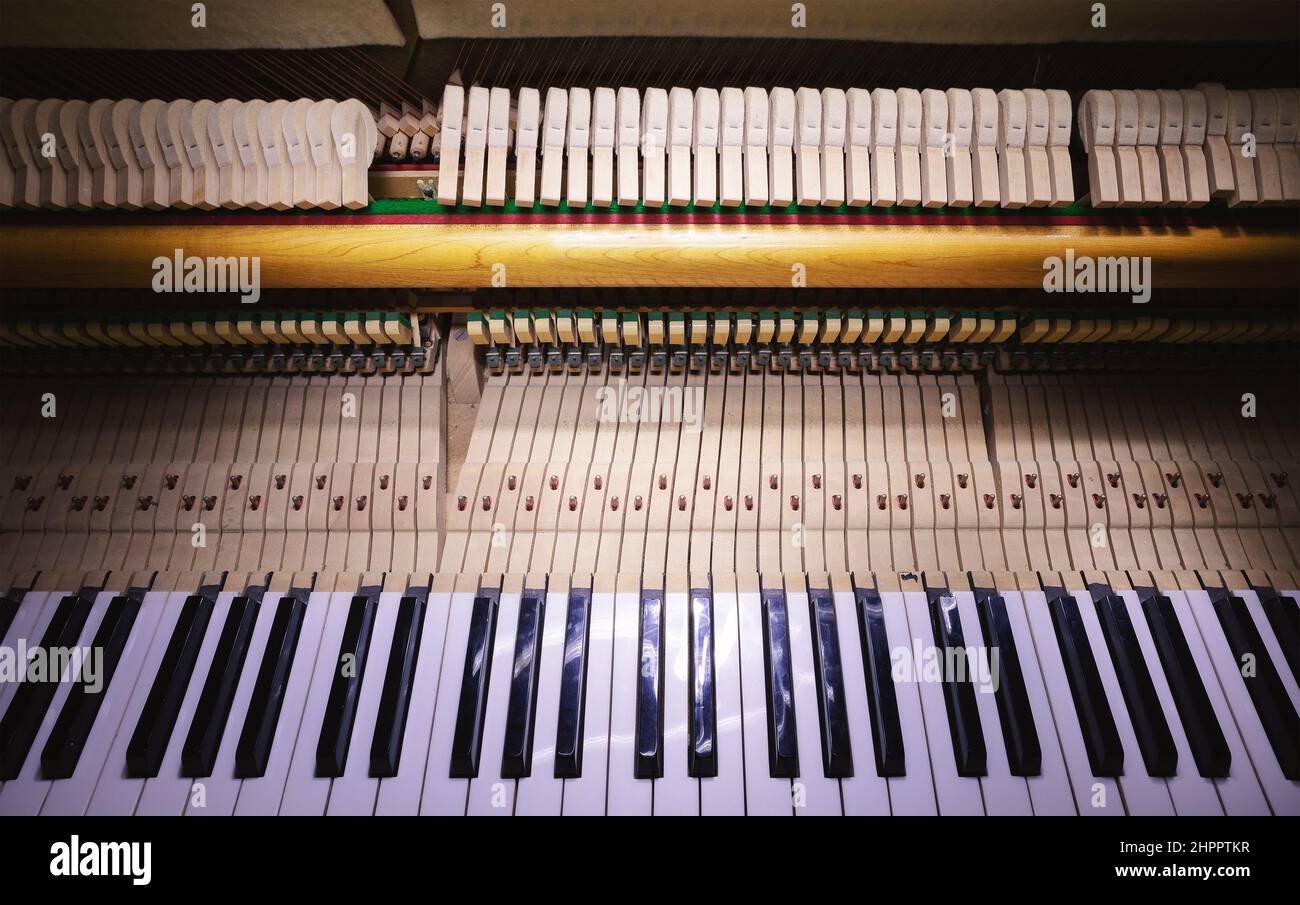 Details of an open upright piano, strings and structure closeup view ...