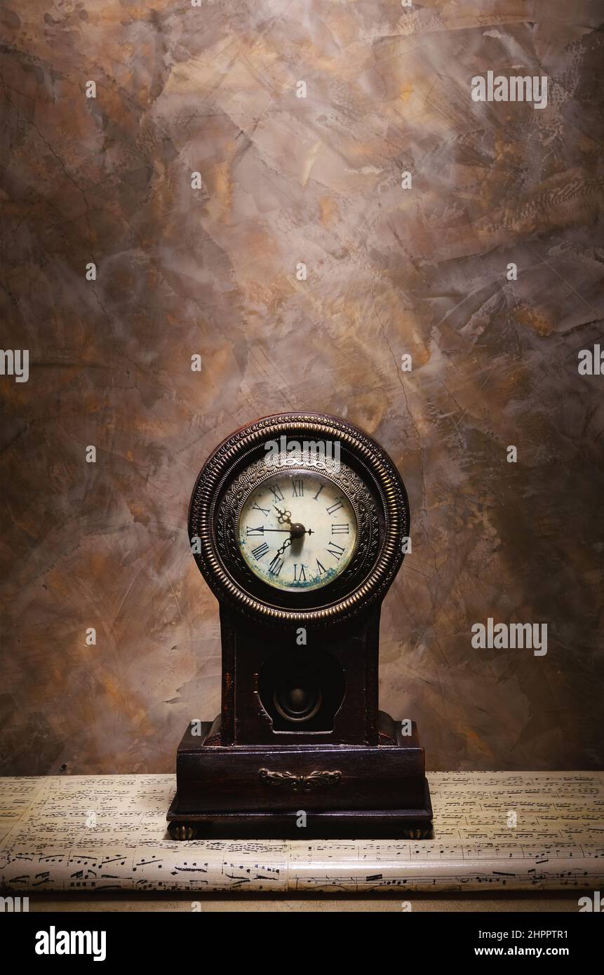Conceptual art, details of an old retro wooden clock on table with ...