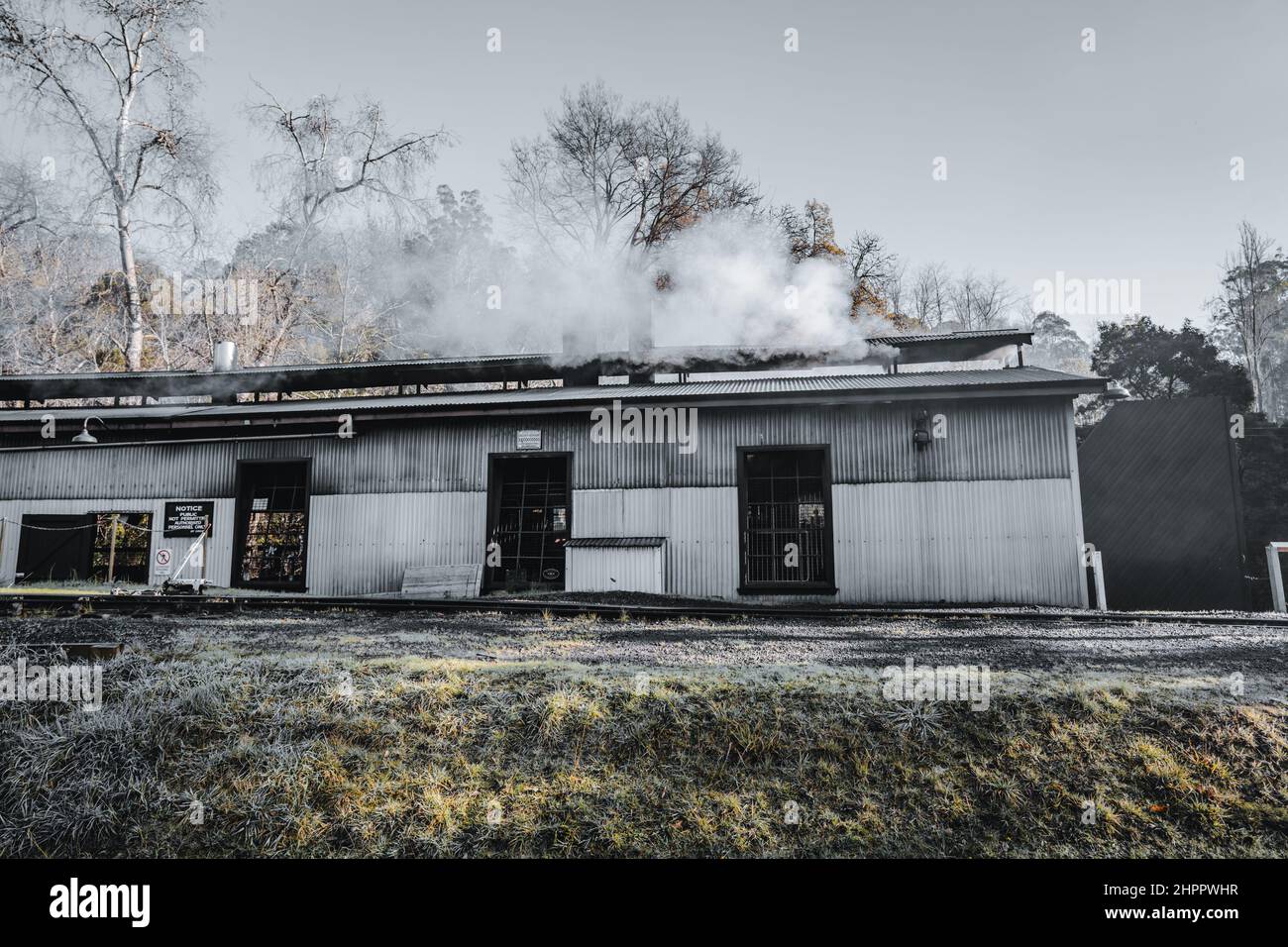 Warehouse with smoke rising Stock Photo - Alamy