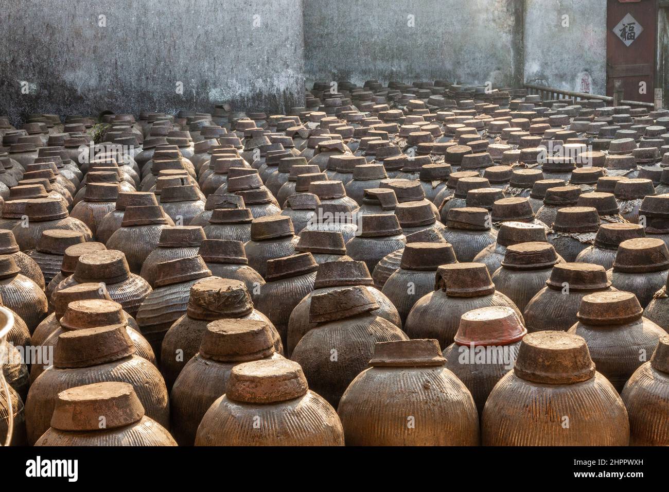 Sealed ceramic jars ensuring fermentation for the preparation of rice ...