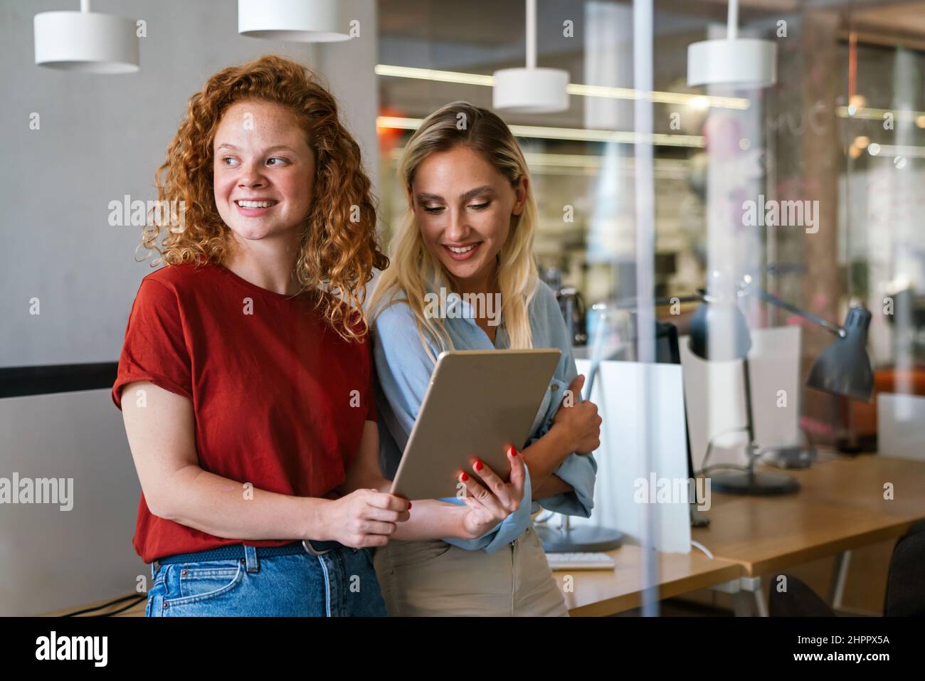 Portrait of happy young people working together and having fun in ...
