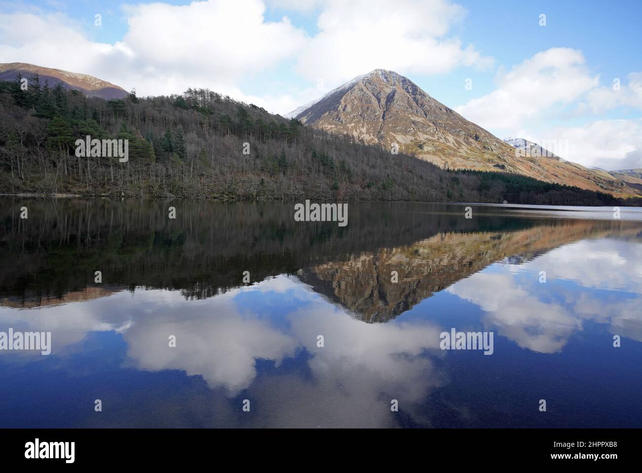 Mount Grasmoor reflected in the still water of Crummock Water in the ...