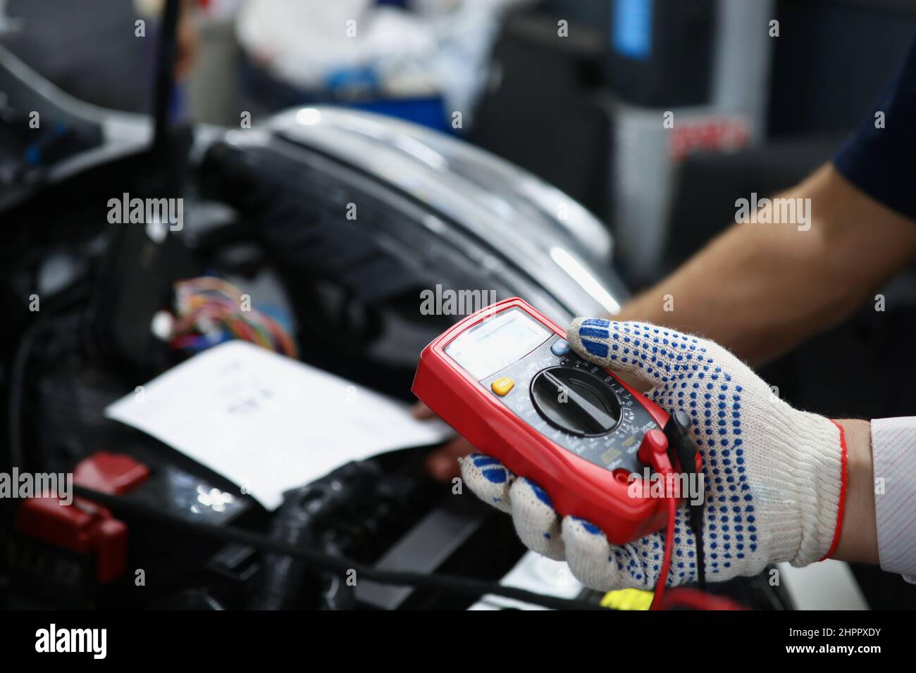 Mechanics hand hold multimeter equipment to measure voltage of ...