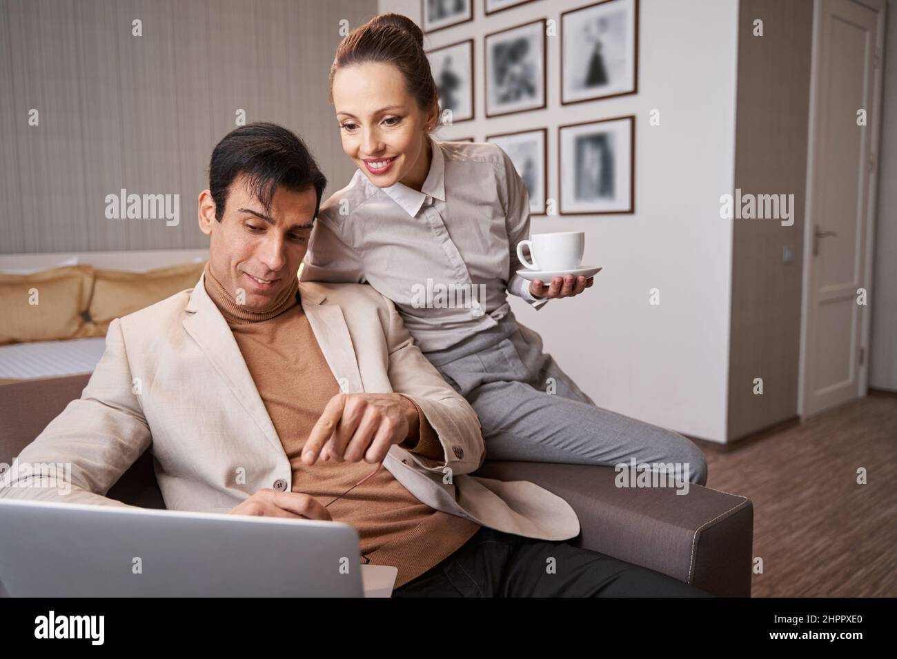 Concentrated male showing something on portable computer to female ...